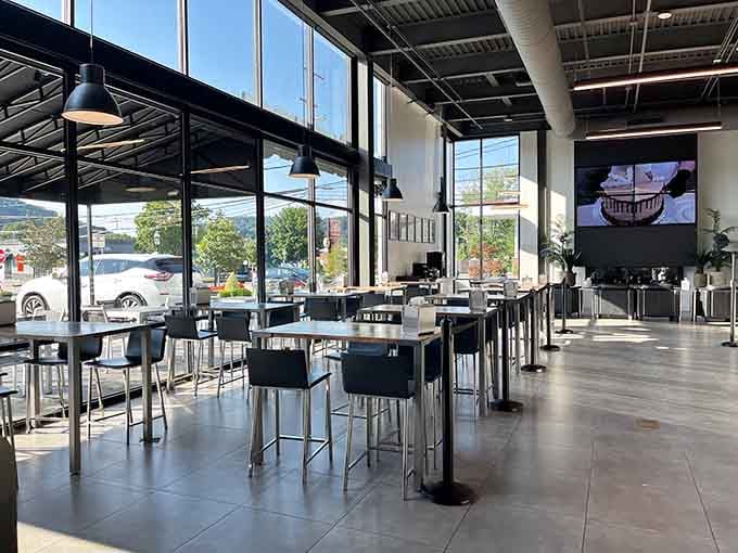Floor-to-ceiling windows flood this bakery cathedral with light, making every pastry look like it deserves its own museum exhibit.