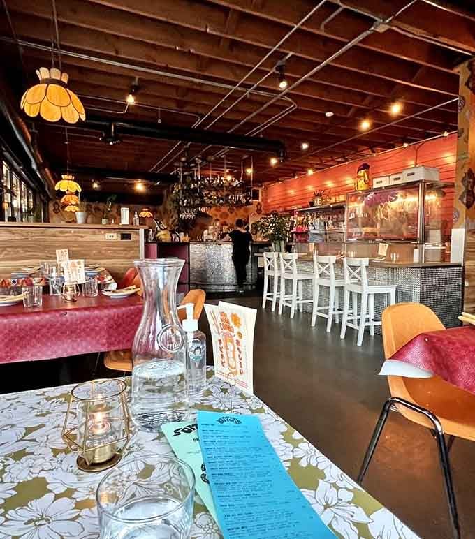 Vintage lamps, floral tablecloths, and velvet seating create the kind of cozy chaos where great meals happen.