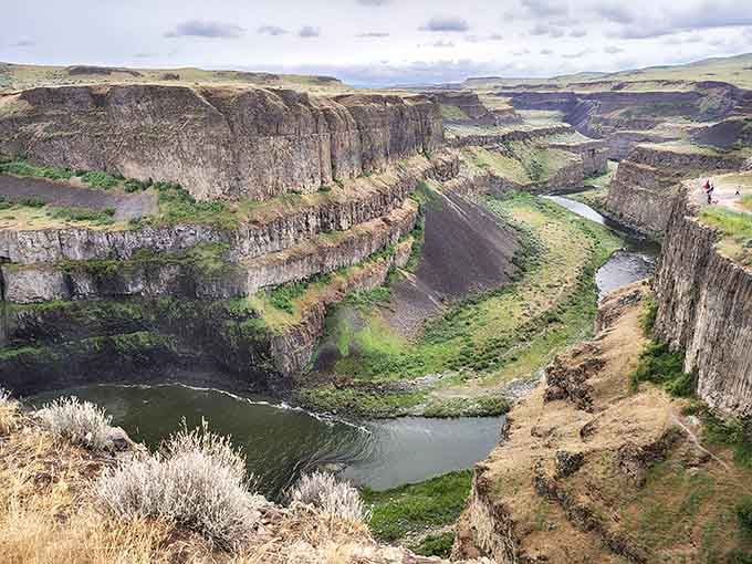 The ancient basalt cliffs frame this geological masterpiece like nature decided to show off its artistic side.