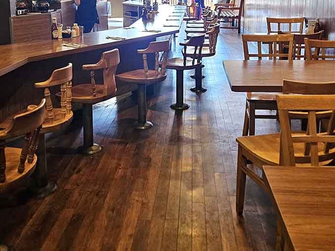 Classic counter seating meets wooden tables in a layout that proves sometimes the best design is no design at all.