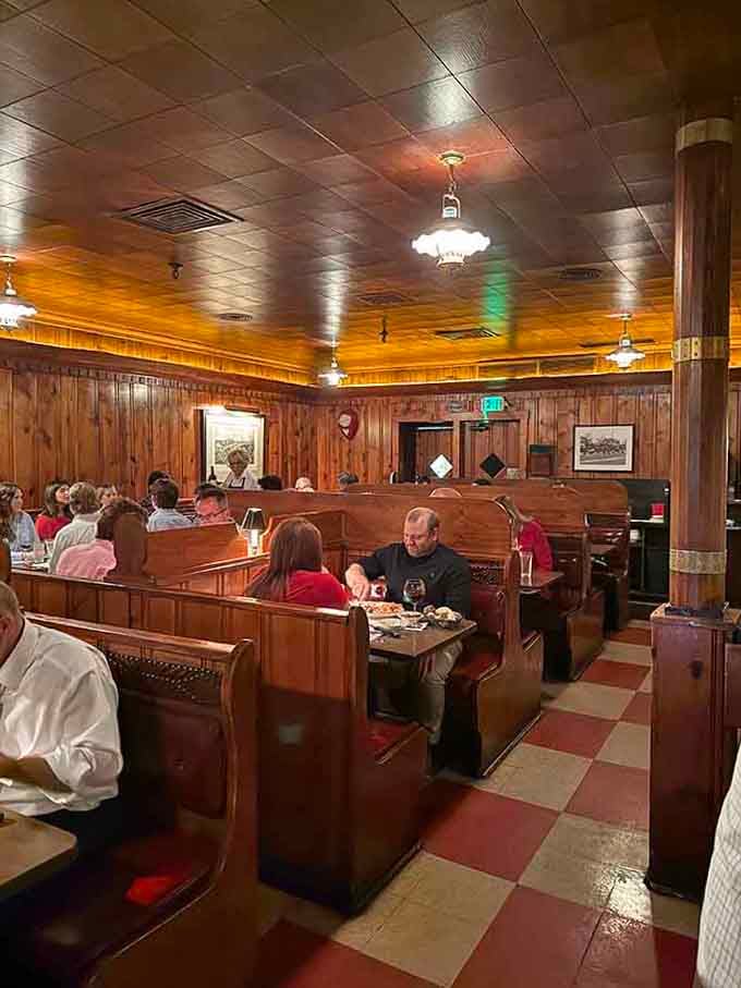 Wood paneling and high-backed booths create the kind of atmosphere where conversations linger as long as dinner.