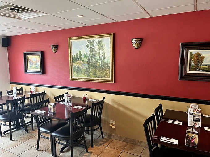Simple red walls and landscape paintings create the perfect backdrop for serious comfort food to shine bright.