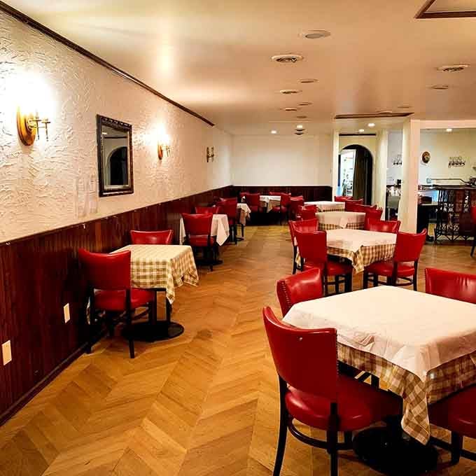 Checkered tablecloths and warm lighting create an atmosphere that whispers "relax, you're among friends now."