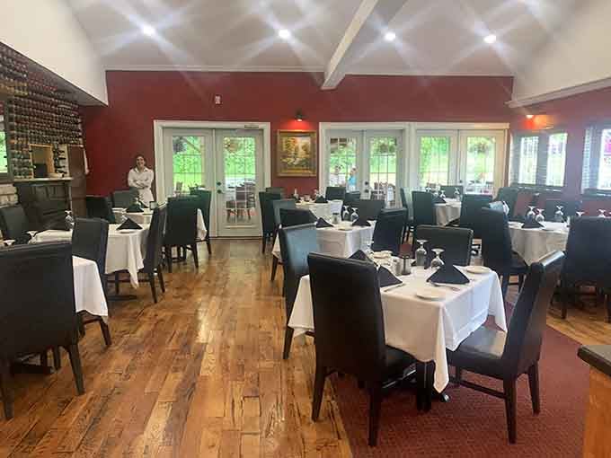 Rich red walls and white tablecloths create an atmosphere where every meal feels like a special occasion worth celebrating.