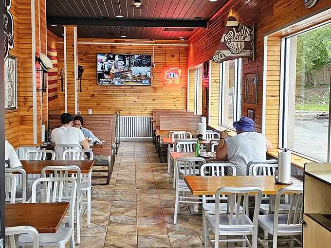 Wood paneling and casual seating create that authentic smokehouse vibe where napkins outnumber utensils three to one.