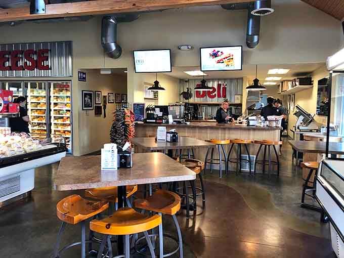 Modern meets rustic in this welcoming space where wooden stools and polished concrete floors set the stage for cheese magic.