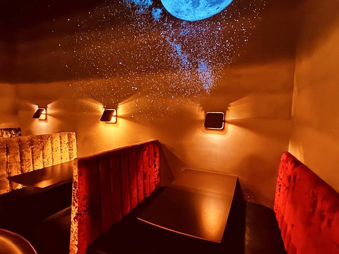 Velvet booths beneath projected galaxies create an intimate cosmic lounge that feels wonderfully out of this world.