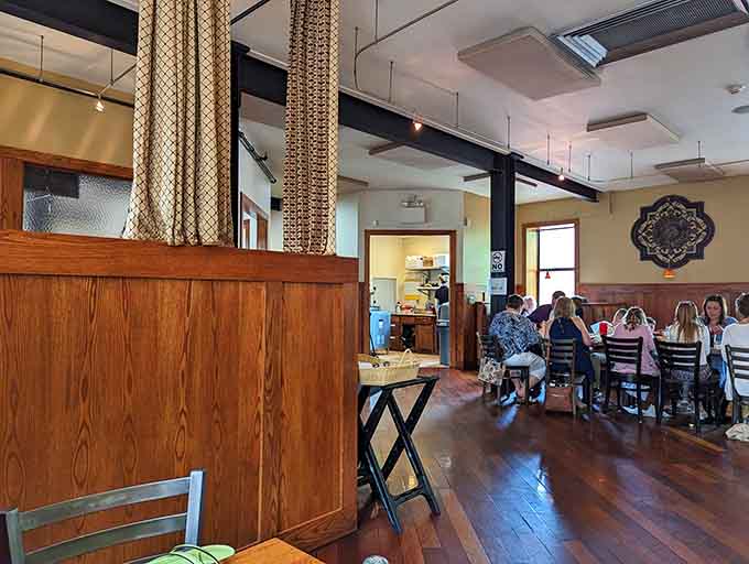 Wood tones create the kind of welcoming atmosphere where strangers become friends over shared plates.