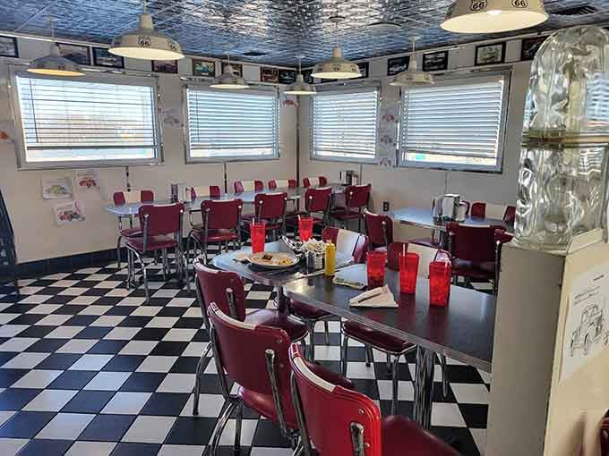Black and white checkered floors and burgundy seats create the perfect backdrop for your breakfast dreams.