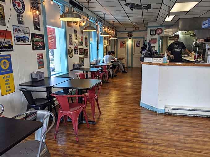 Vintage signs and red metal chairs create the perfect backdrop for serious burger consumption and zero regrets.