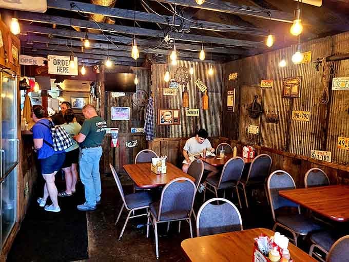 Edison bulbs and corrugated metal create the kind of atmosphere where strangers become friends over shared platters.