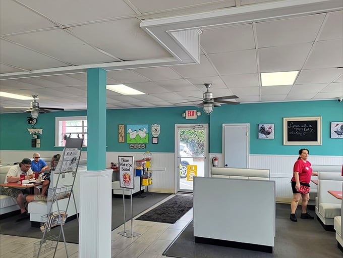 Turquoise walls and classic booth seating create the perfect backdrop for your morning feast.