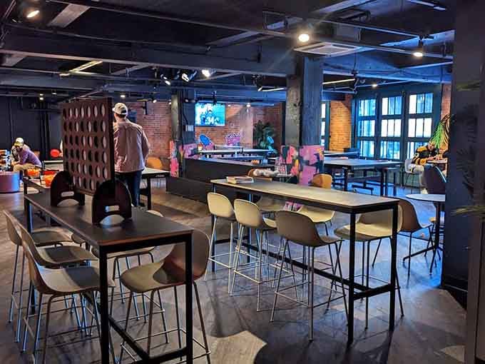 Industrial chic meets playful energy in a space where exposed brick and ping pong tables coexist beautifully.
