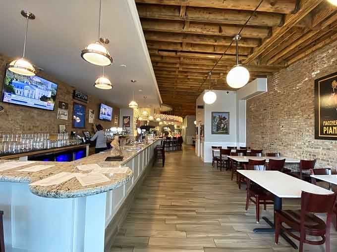 Exposed brick, warm lighting, and that gorgeous wood-fired oven create an atmosphere worth savoring slowly.