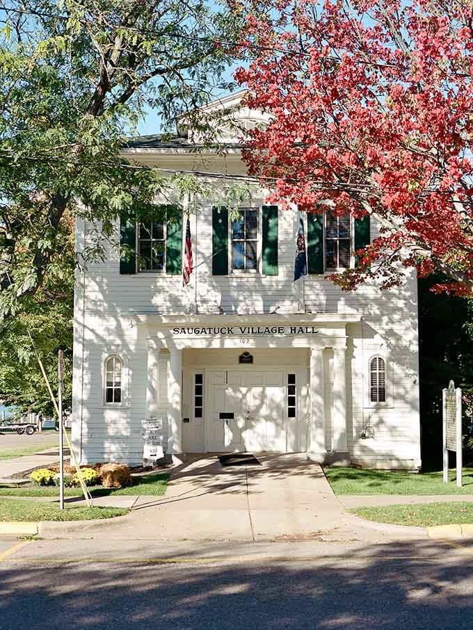The historic Village Hall stands proud with its classic white facade, looking like it walked straight out of a Norman Rockwell painting.