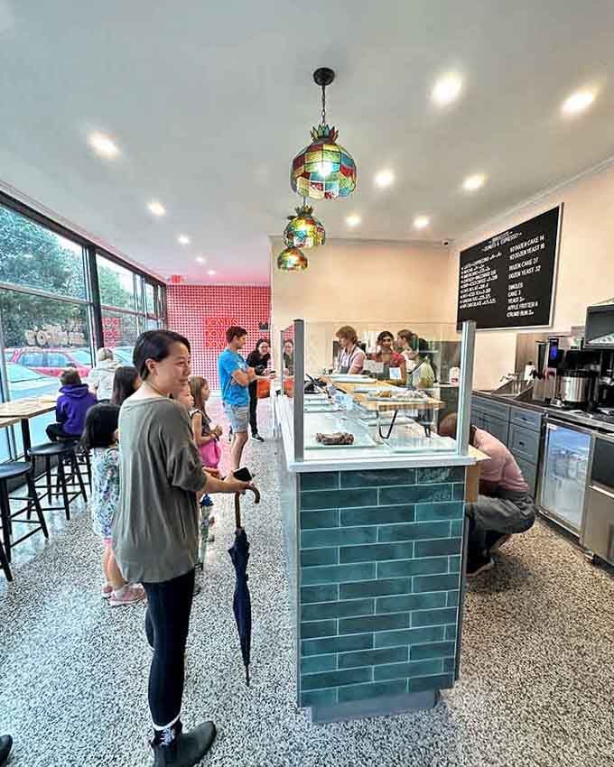 Colorful pendant lights and terrazzo floors create a cheerful vibe that matches the donuts perfectly.