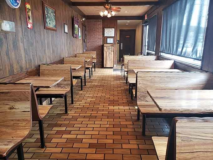 Simple wooden tables and brick floors create the kind of honest dining space that never goes out of style.