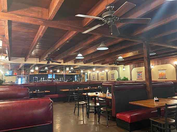Dark wood beams and burgundy booths create the kind of timeless steakhouse atmosphere that never goes out of style.