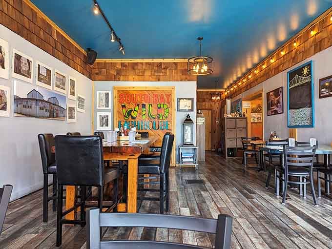 Warm wood tones and nautical touches create a space that feels both cozy and authentically coastal.