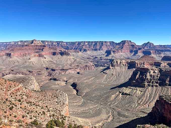 Layer upon layer of geological history unfolds before you, each stratum telling stories millions of years in the making.