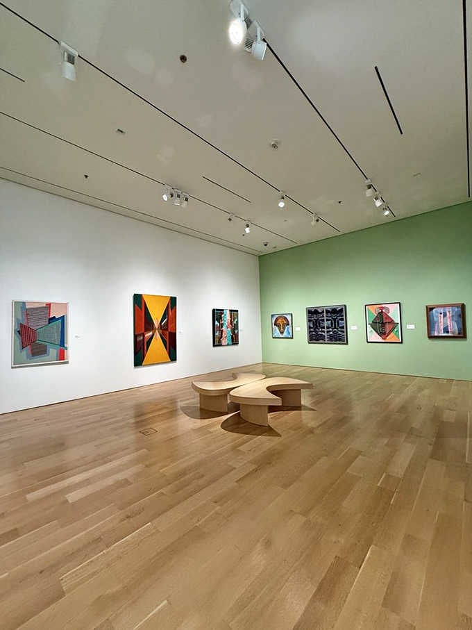 Clean lines and bold colors create gallery spaces where modern art feels right at home on mint-green walls.