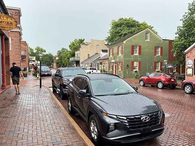 Rain-slicked brick streets reflect colorful buildings, proving even bad weather can't diminish this town's photogenic qualities.
