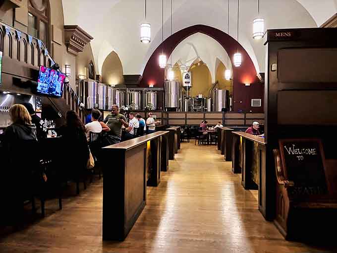 Where pews once stood, beer lovers now gather beneath soaring arches that make every sip feel downright sacred.
