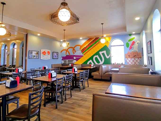 Those colorful murals and cozy booths create an atmosphere that feels like stepping into a happier, simpler time.