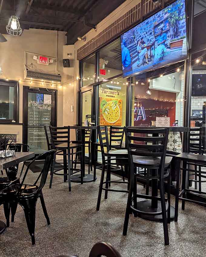 Modern industrial chic meets neighborhood hangout vibes, where exposed ceilings and string lights create pizza-eating perfection.