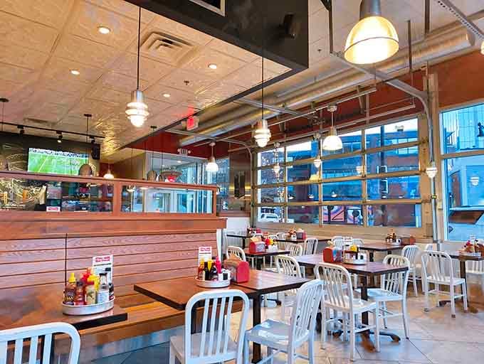 Clean lines, metal chairs, and an open kitchen where burger magic happens right before your grateful eyes.