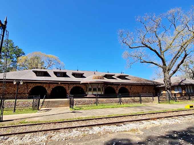 The stone depot building whispers stories of countless journeys, waiting patiently for your adventure to begin today.