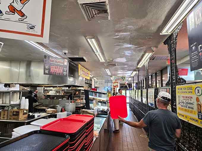 Behind the counter, organized chaos reigns as orders fly faster than you can say "cheeseburger, hold the regrets."