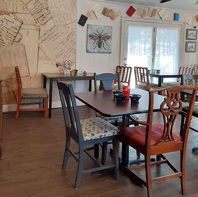 Mismatched chairs and literary walls create the cozy living room you wish you had at home.