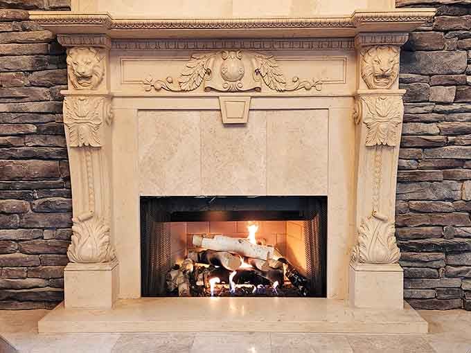 This fireplace mantel has more ornate detail than most people's entire living rooms, and honestly, it's completely justified here.