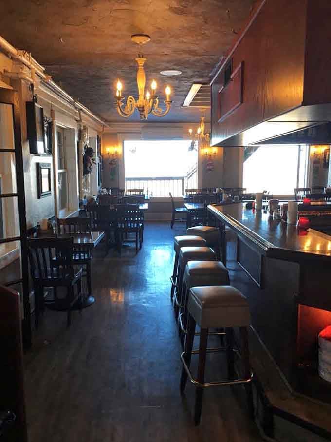 Step inside where vintage chandeliers meet mountain charm, proving atmosphere matters as much as the menu.