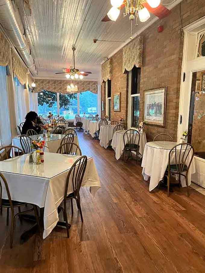 Chandeliers and crisp white tablecloths transform a historic home into an elegant dining room with serious charm.