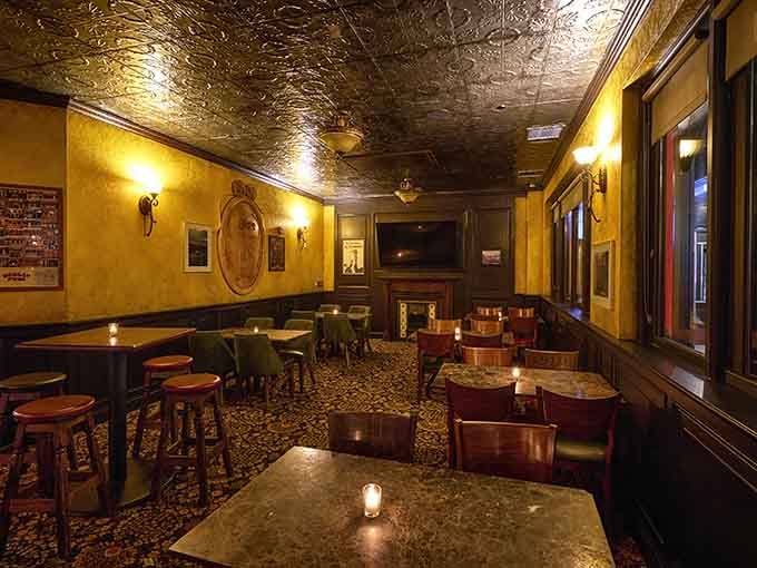 Golden tin ceilings and warm lighting create an atmosphere that feels like a hug from your favorite uncle.