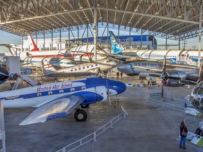The Great Gallery showcases decades of flight evolution, from propeller-driven classics to modern Boeing marvels overhead.