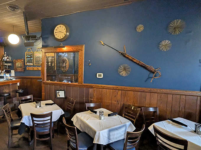 Blue walls, white tablecloths, and wood paneling create an atmosphere where comfort meets class without any fuss.