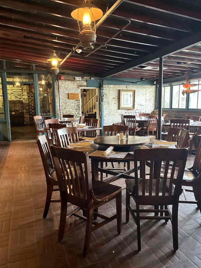 Exposed beams and whitewashed brick create an ambiance that whispers tales of seafarers while you settle into comfortable modern seating.