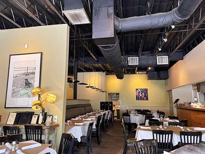 Inside, exposed black ceilings and white tablecloths create drama without the melodrama, perfectly balancing industrial edge with refined dining.