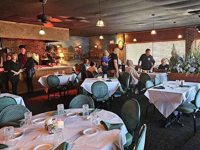 White tablecloths and exposed brick create an atmosphere where anniversaries feel celebrated and Tuesdays feel like special occasions.
