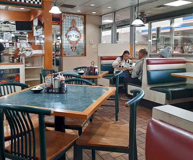Classic booth seating and vintage signage create the perfect backdrop for serious breakfast contemplation and coffee consumption.