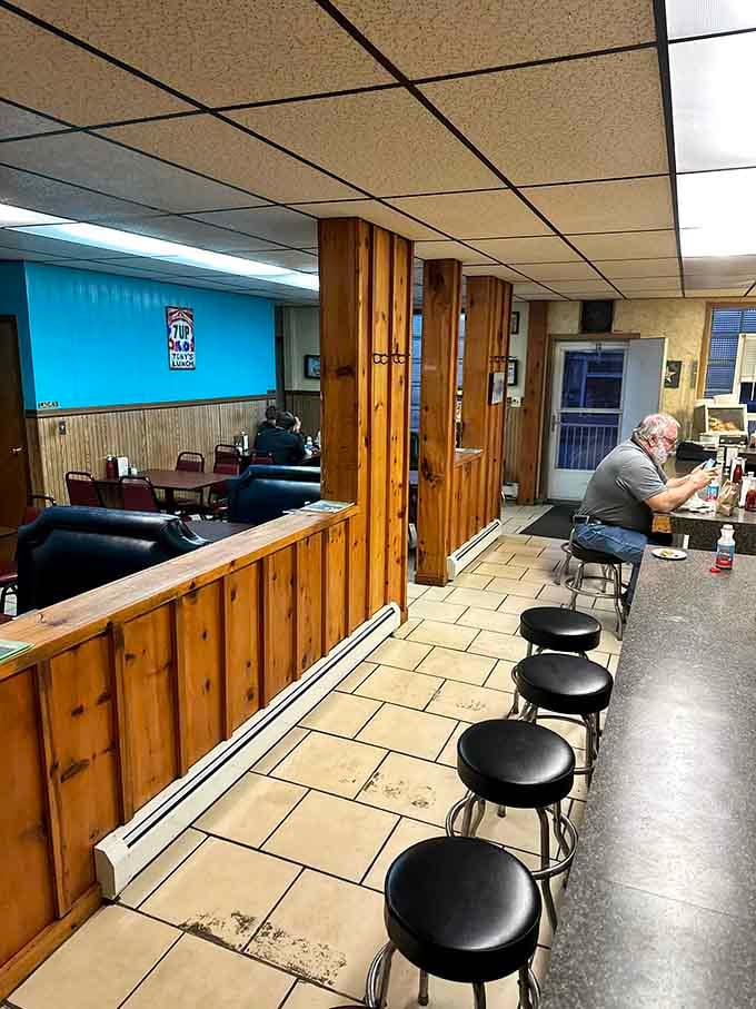 Classic lunch counter vibes with dollar bills plastering the walls&mdash;each one a love letter to legendary burgers.