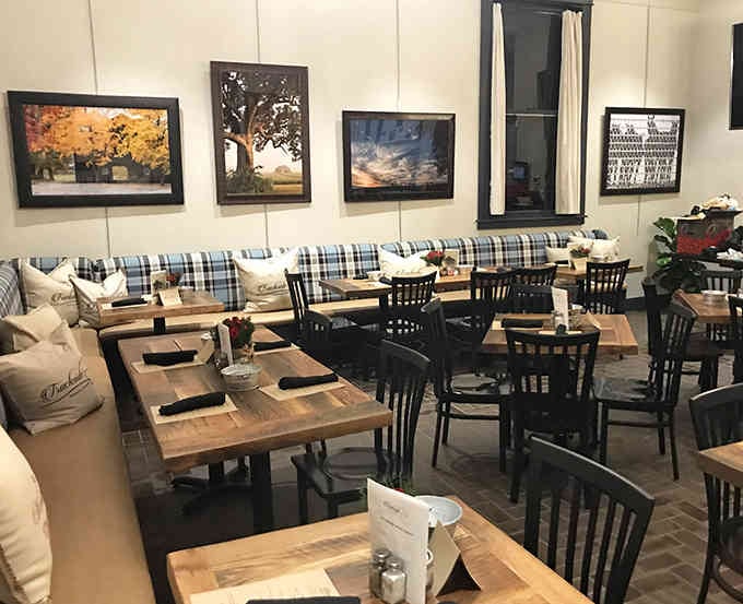 Cozy banquettes, warm lighting, and framed local photography create the perfect backdrop for lingering over wood-fired pizza.