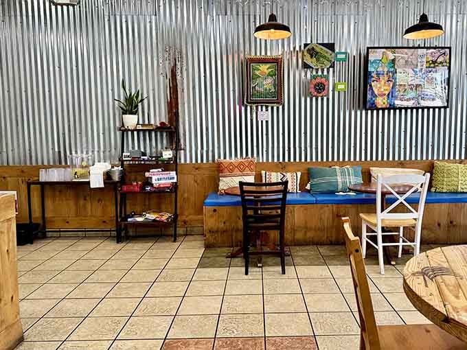 Corrugated metal, colorful art, and mismatched chairs create an atmosphere that's effortlessly cool without trying too hard.