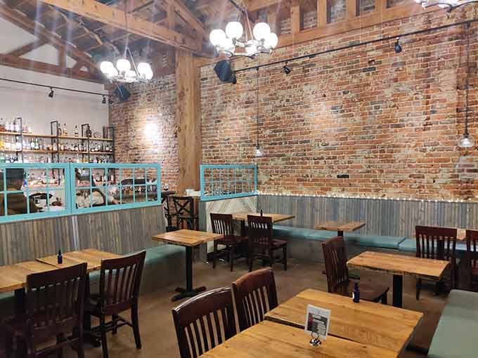 Exposed brick and turquoise accents create a dining room that's equal parts historic charm and modern mountain sophistication.