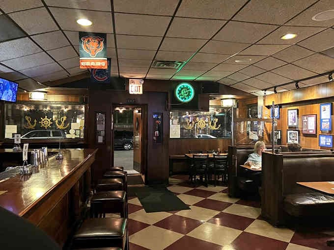 Step inside and the checkered floor, dark wood booths, and glowing neon transport you to another era.