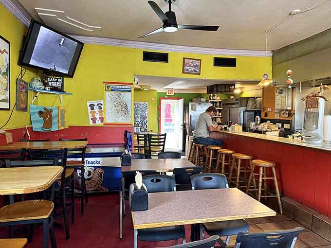 Yellow walls and red accents create the kind of cheerful atmosphere that makes every meal feel like a celebration.