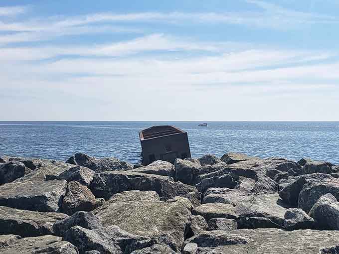 The rocky shoreline frames this concrete oddity perfectly, like nature's way of saying "we'll allow it" to human engineering gone rogue.